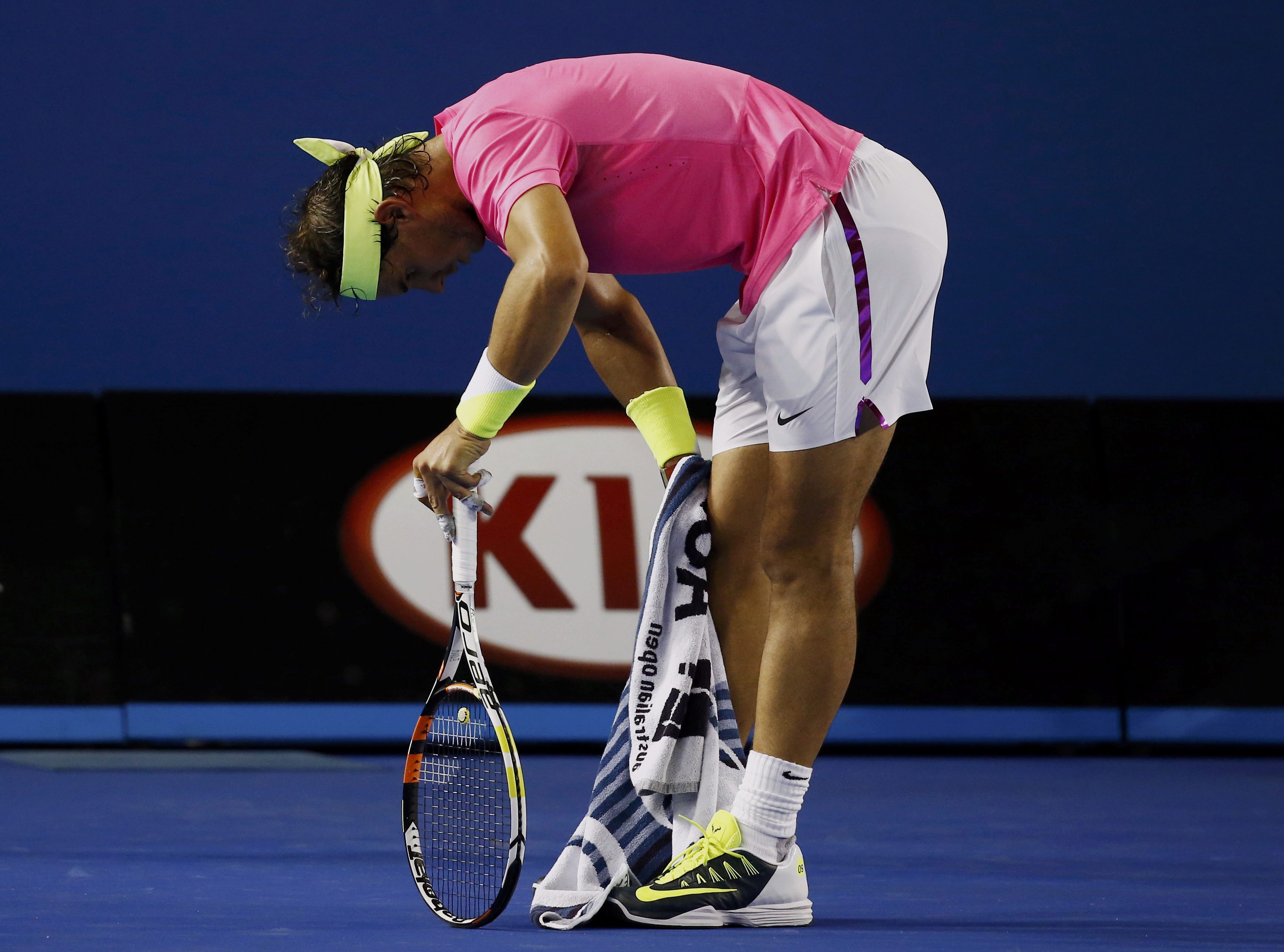 Nadal of Spain leans on his racket during his men’s singles second ...